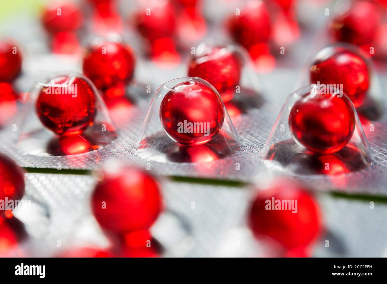 Metal drug blister with red medicine capsules Stock Photo - Alamy