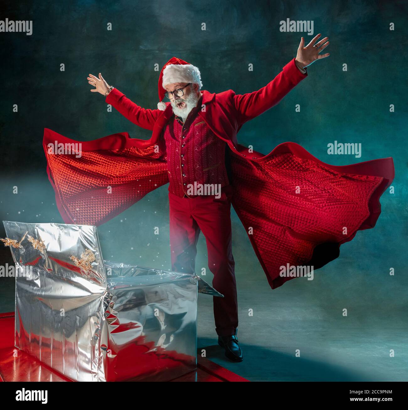 Magic glowing. Modern stylish Santa Claus in red fashionable suit and ...