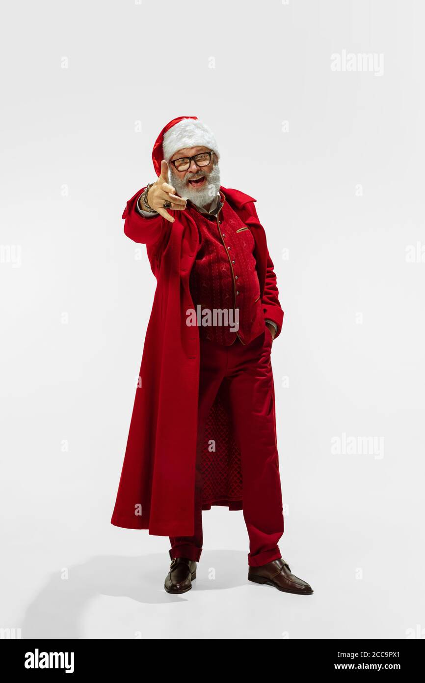 Choosing you. Modern stylish Santa Claus in red fashionable suit ...