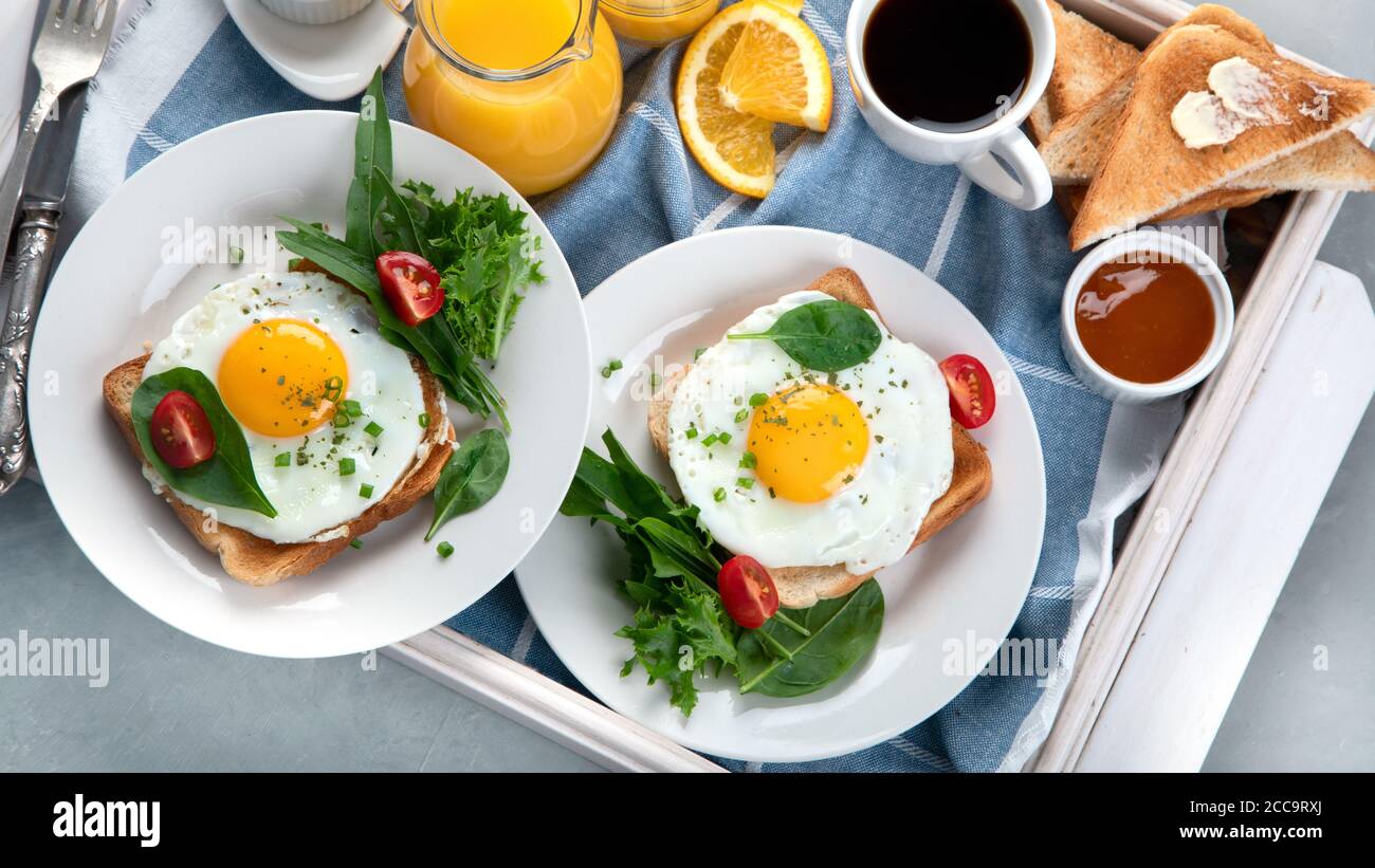 Traditional breakfast served in white wooden tray on grey background ...
