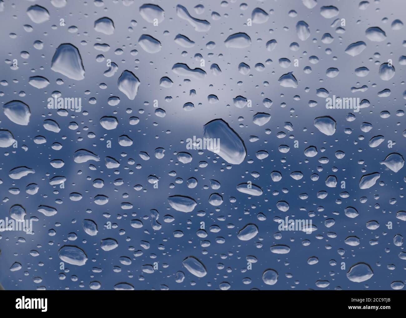 Abstract Screensaver rain droplets on the sunroof from a caravan ...