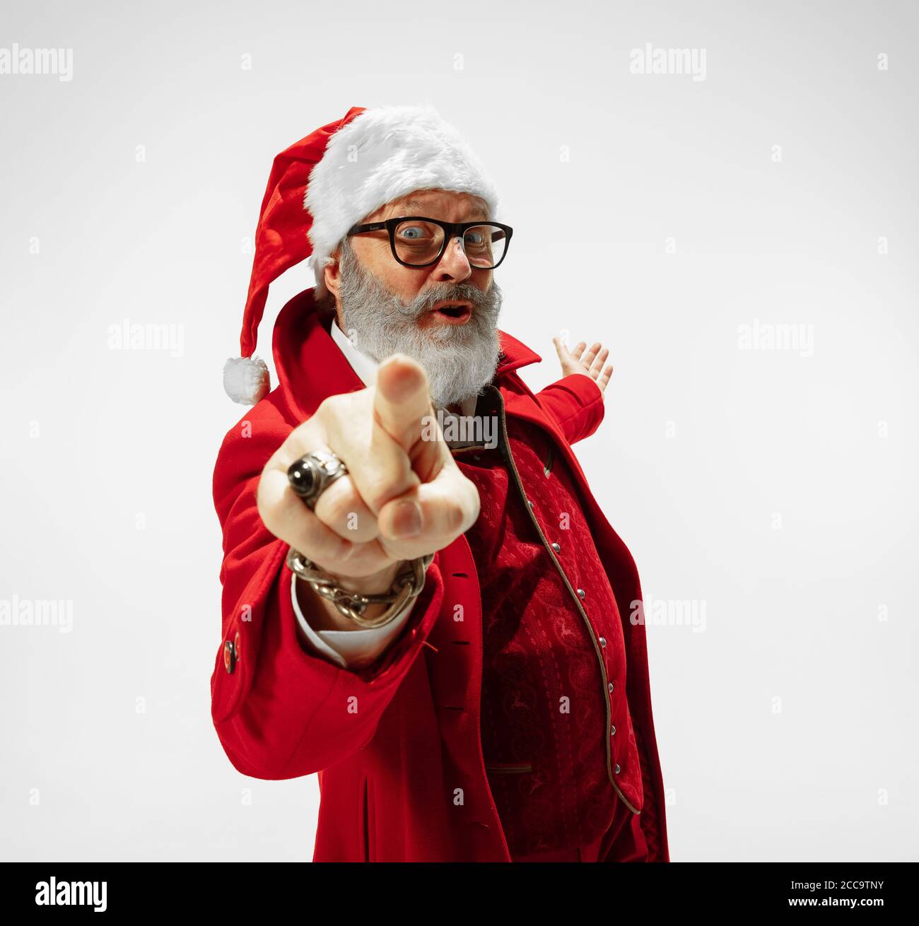 Choosing you. Modern stylish Santa Claus in red fashionable suit ...