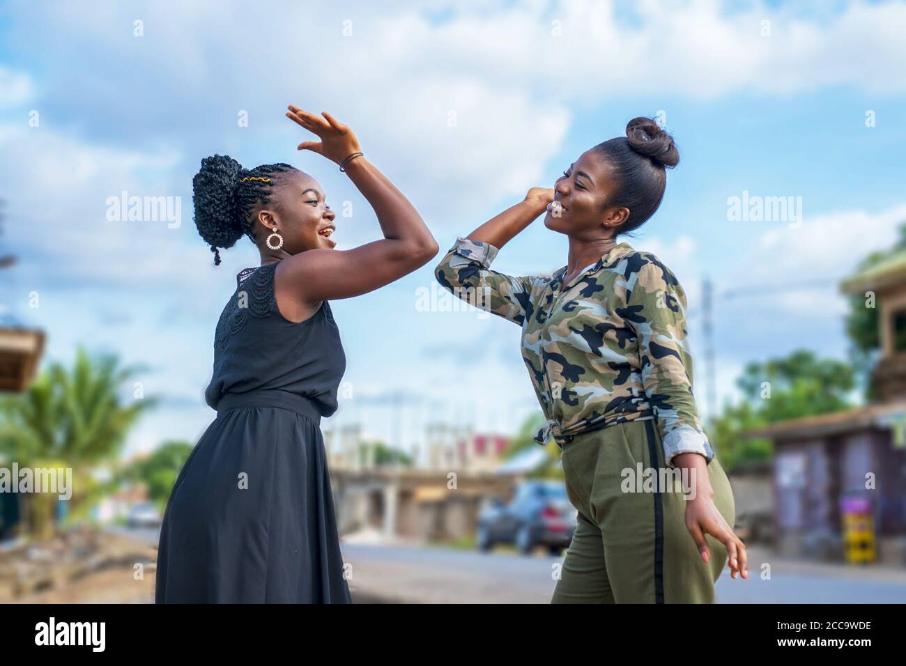 Two young black females smiling and high-fiving each other Stock Photo ...