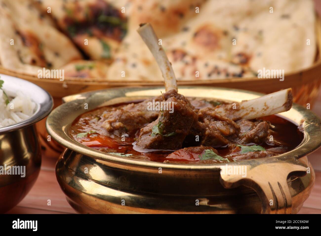 Mutton curry Served with naan or bread and jeera rice over wooden ...