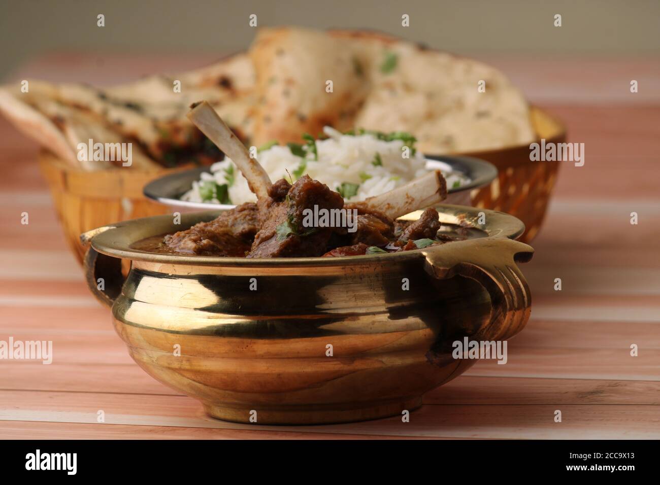 Mutton curry Served with naan or bread and jeera rice over wooden ...