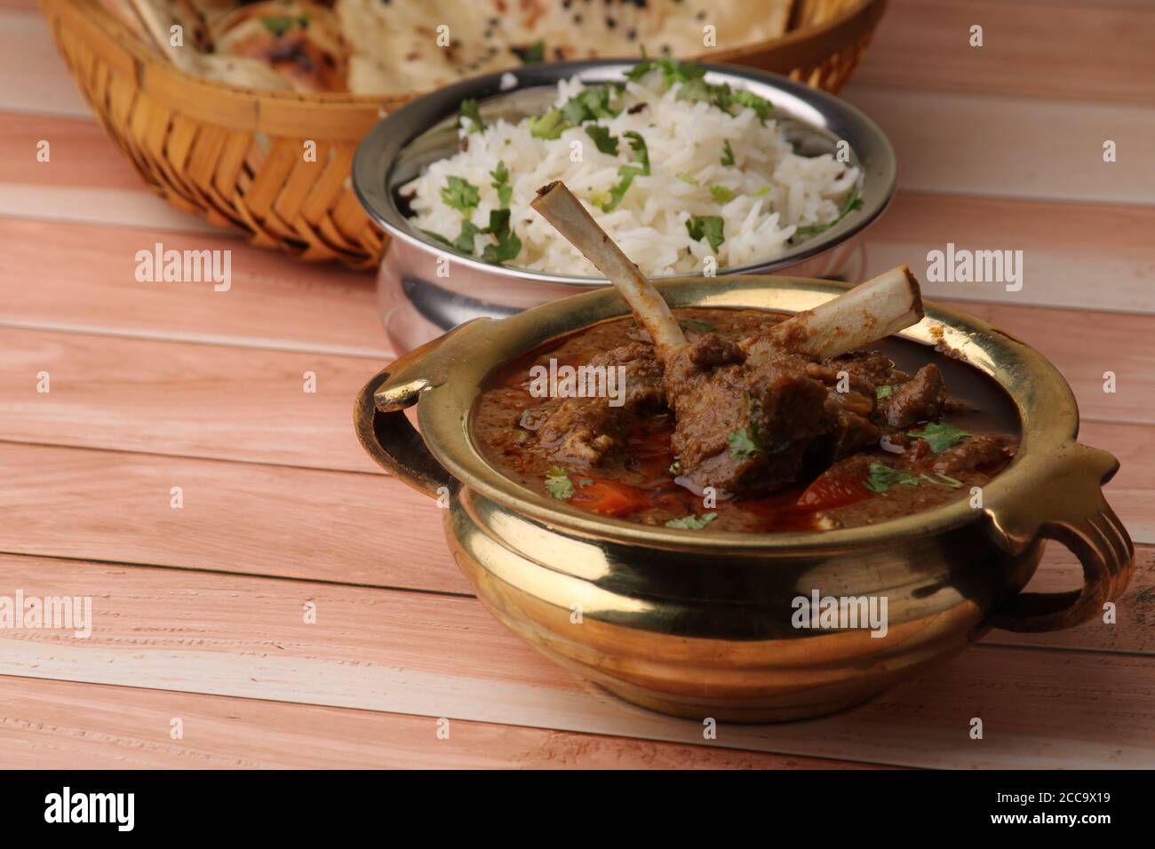 Mutton curry Served with naan or bread and jeera rice over wooden ...