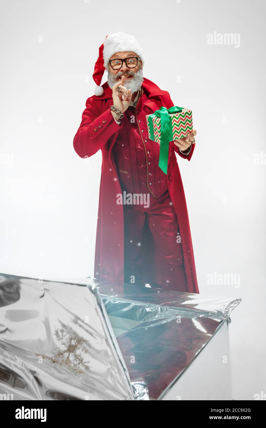 Gifts for good. Modern stylish Santa Claus in red fashionable suit ...