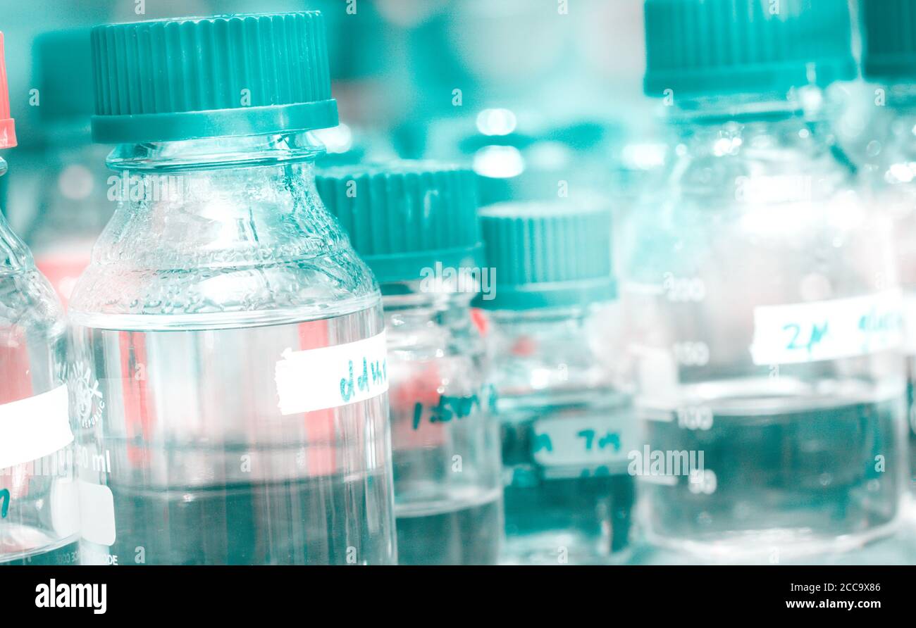 Rows of liquid chemicals in bottles at chemistry Stock Photo - Alamy