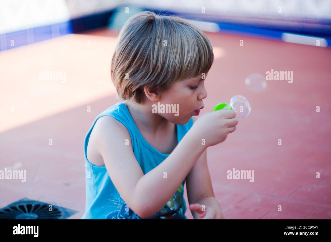 Adorable little boy playing and blowing bubbles Stock Photo - Alamy