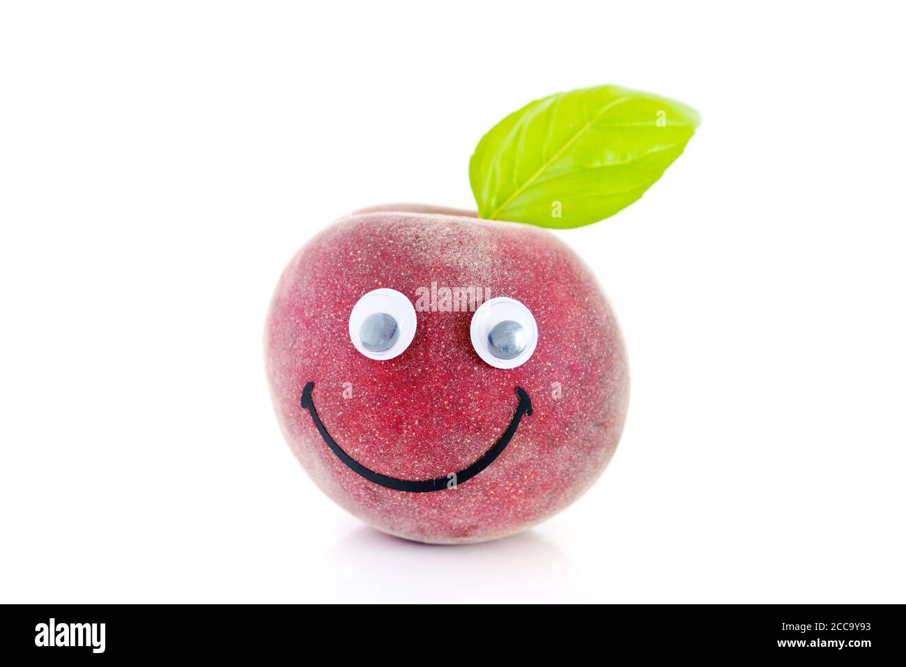 Fruit with a smile and eyes. Smiling peach Stock Photo - Alamy