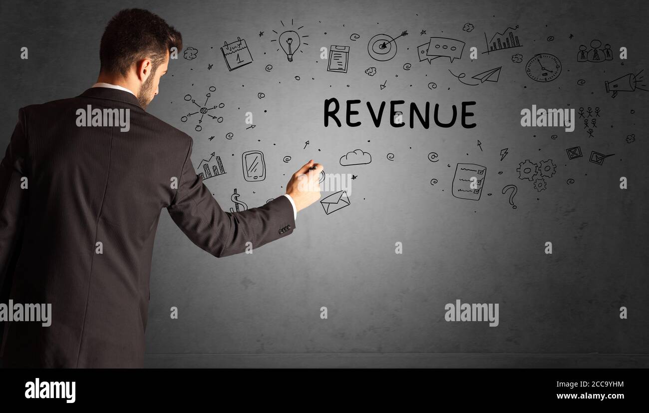 businessman drawing a creative idea sketch with REVENUE inscription ...