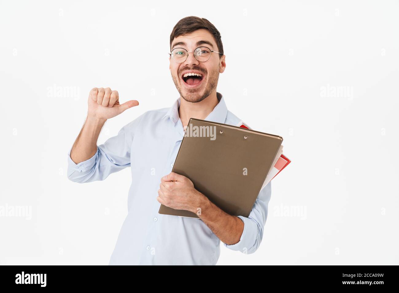 Photo of joyful handsome man holding file with documents and pointing ...