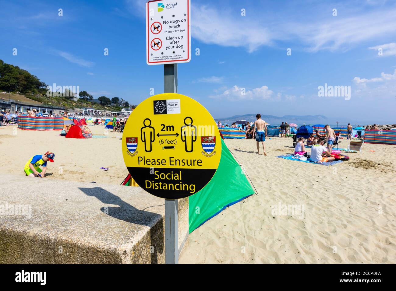 Sign on the beach: Please ensure social distancing, at Lyme Regis, a ...