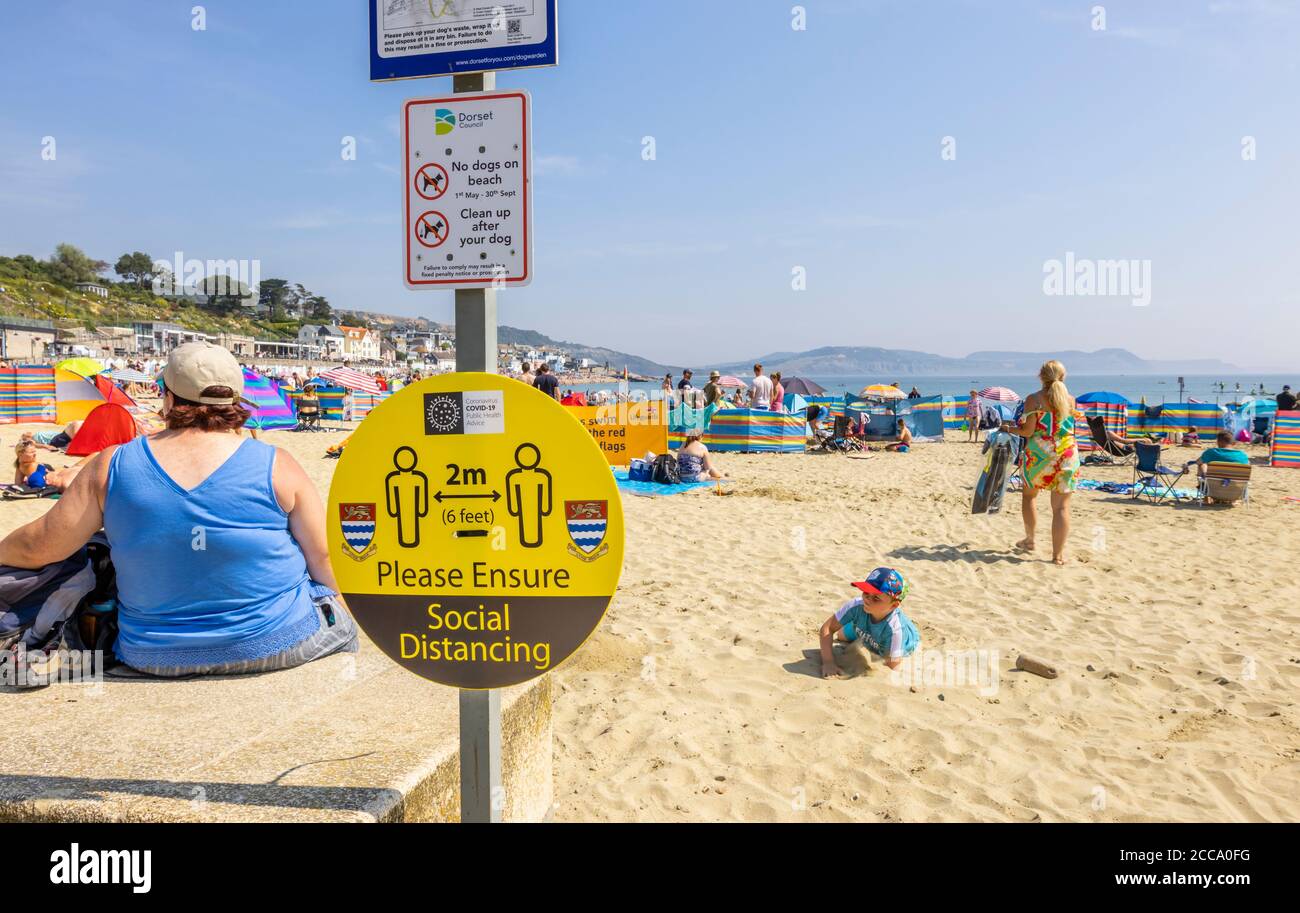 Sign on the beach: Please ensure social distancing, at Lyme Regis, a ...