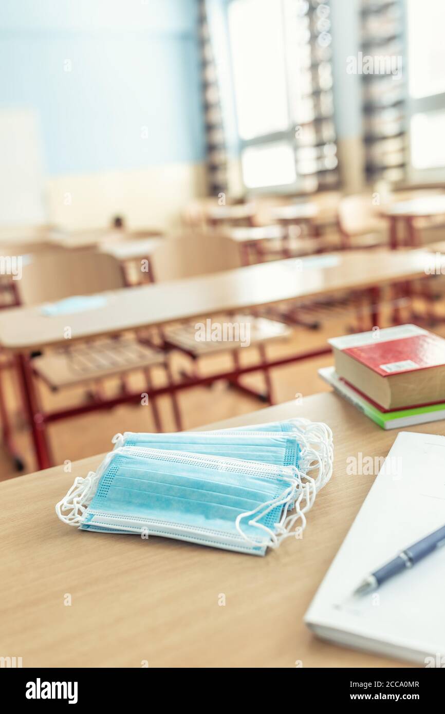 Face mask on a teachers and school desk in a school classroom Stock ...