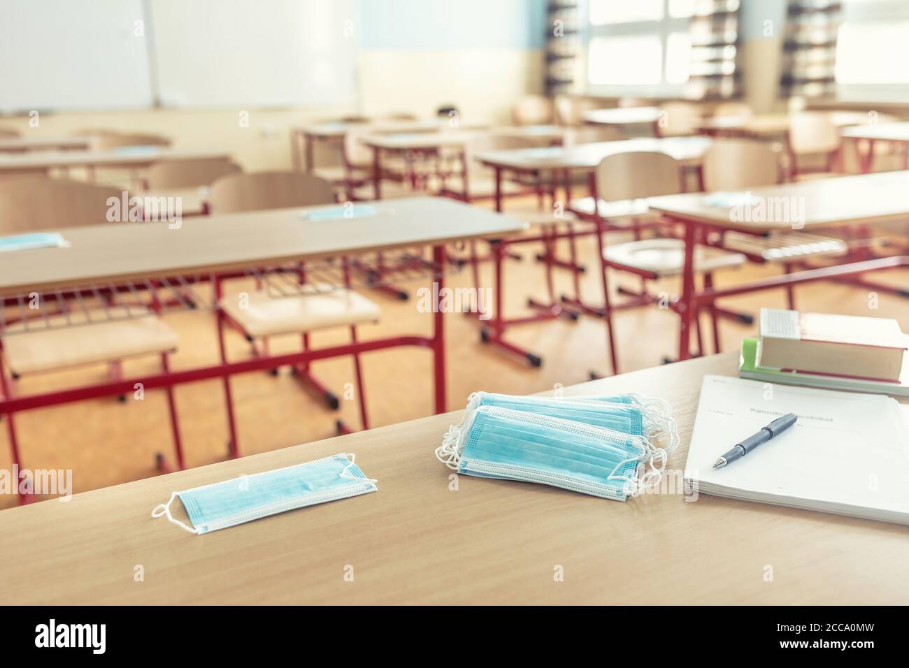 Face mask on a teachers and school desk in a school classroom Stock ...