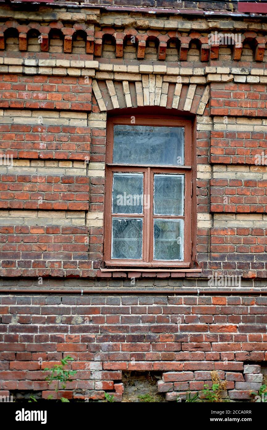 An old brick house with old masonry and windows.An old crumbling ...