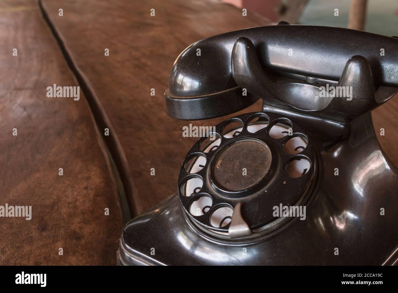 Old Beige phone retro on a wood table Stock Photo - Alamy