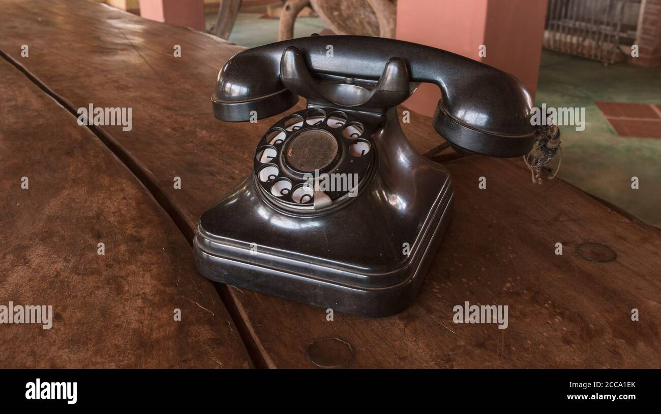 Old Beige phone retro on a wood table Stock Photo - Alamy
