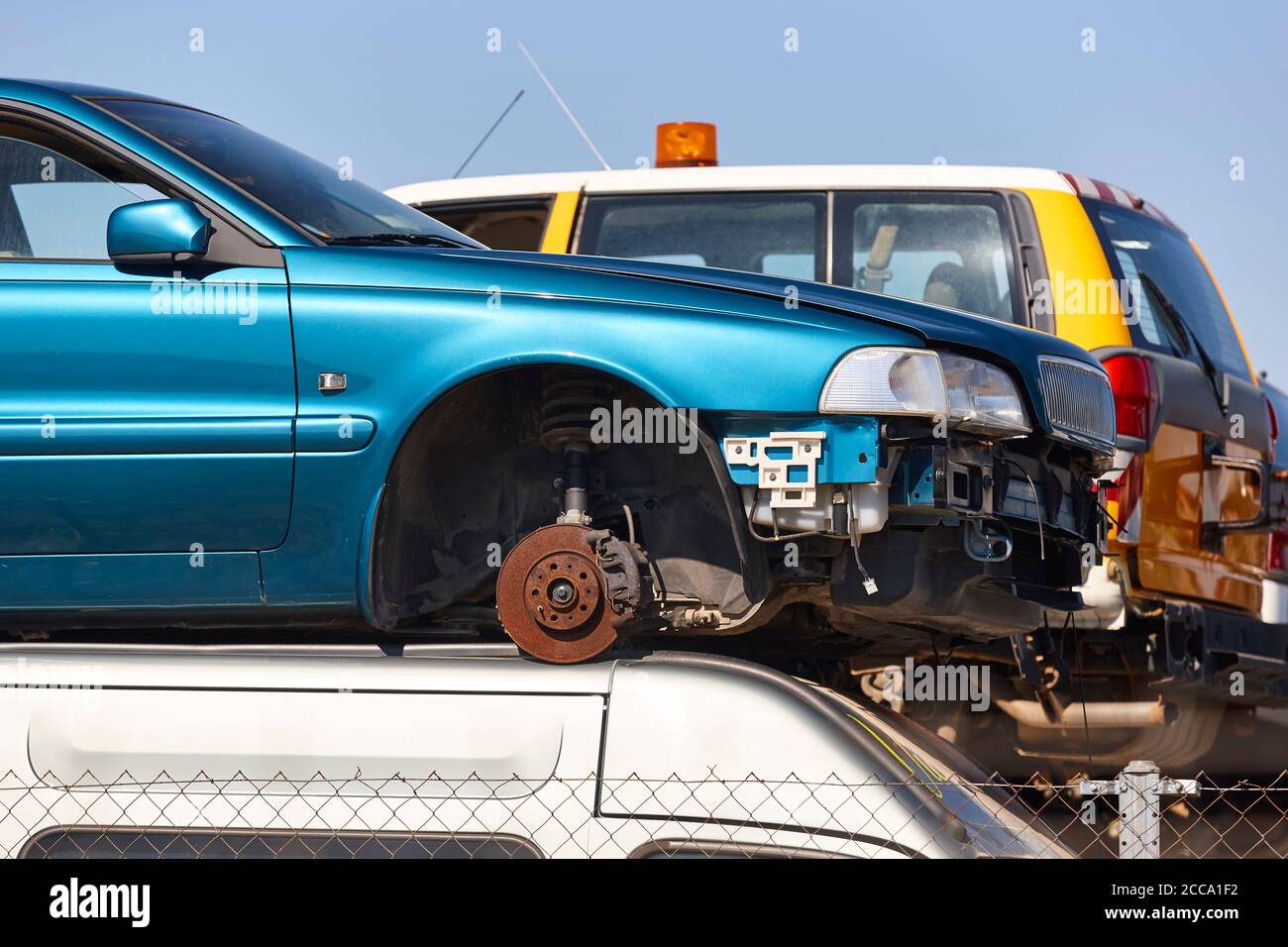 Car scrapyard. Stacked damaged vehicles ready to be recycling ...