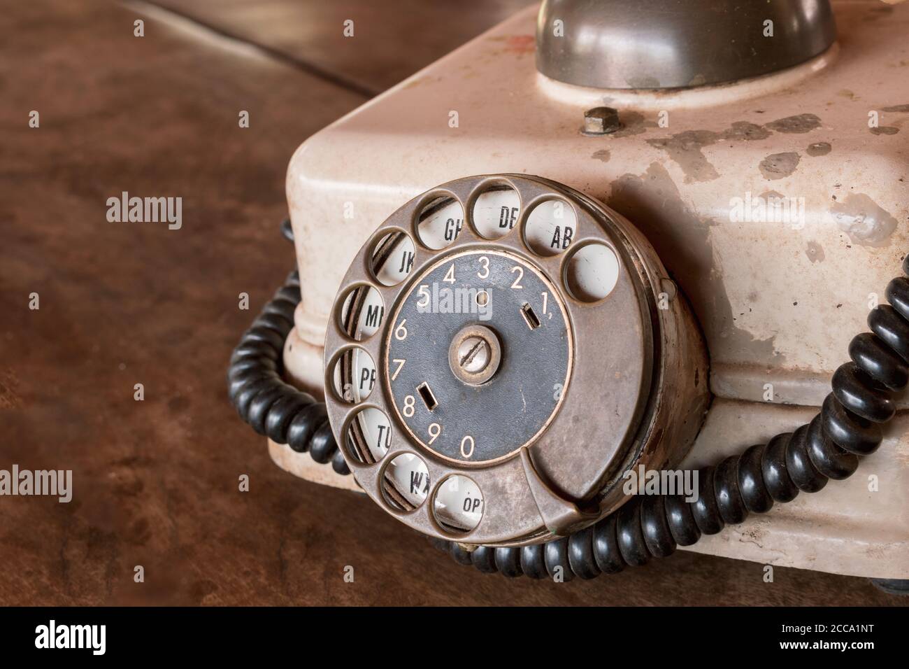 Old Beige phone retro on a wood table Stock Photo - Alamy