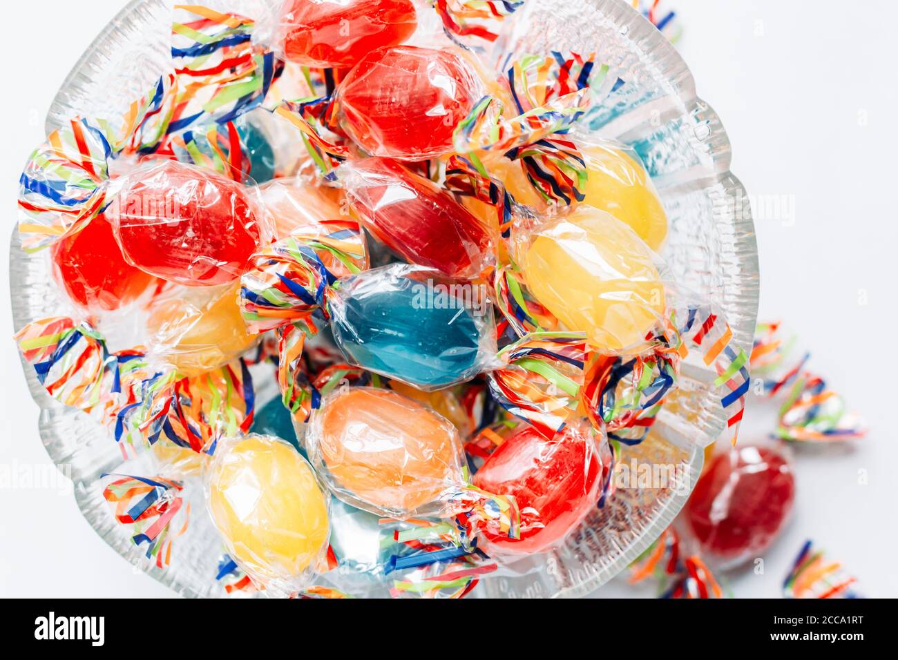 Bowl full with mix hard wrapped candies isolated on white background ...