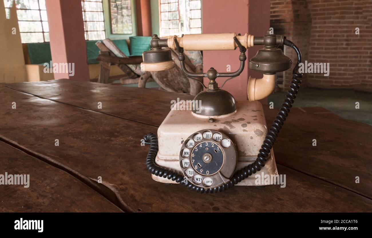 Old Beige phone retro on a wood table Stock Photo - Alamy