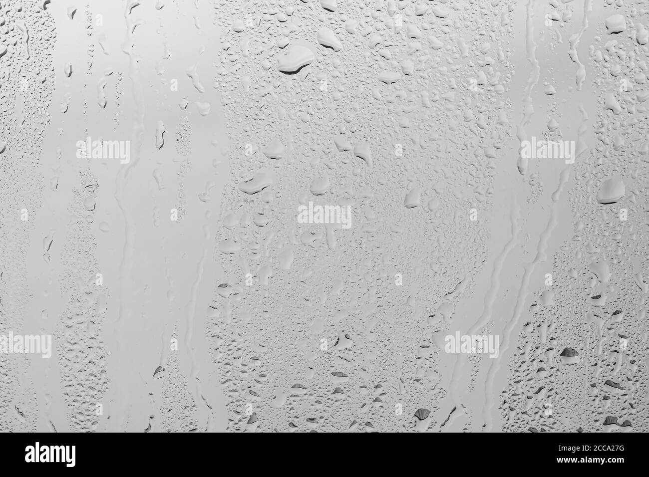 Rain drops on window glasses surface with gray sky background . Natural ...