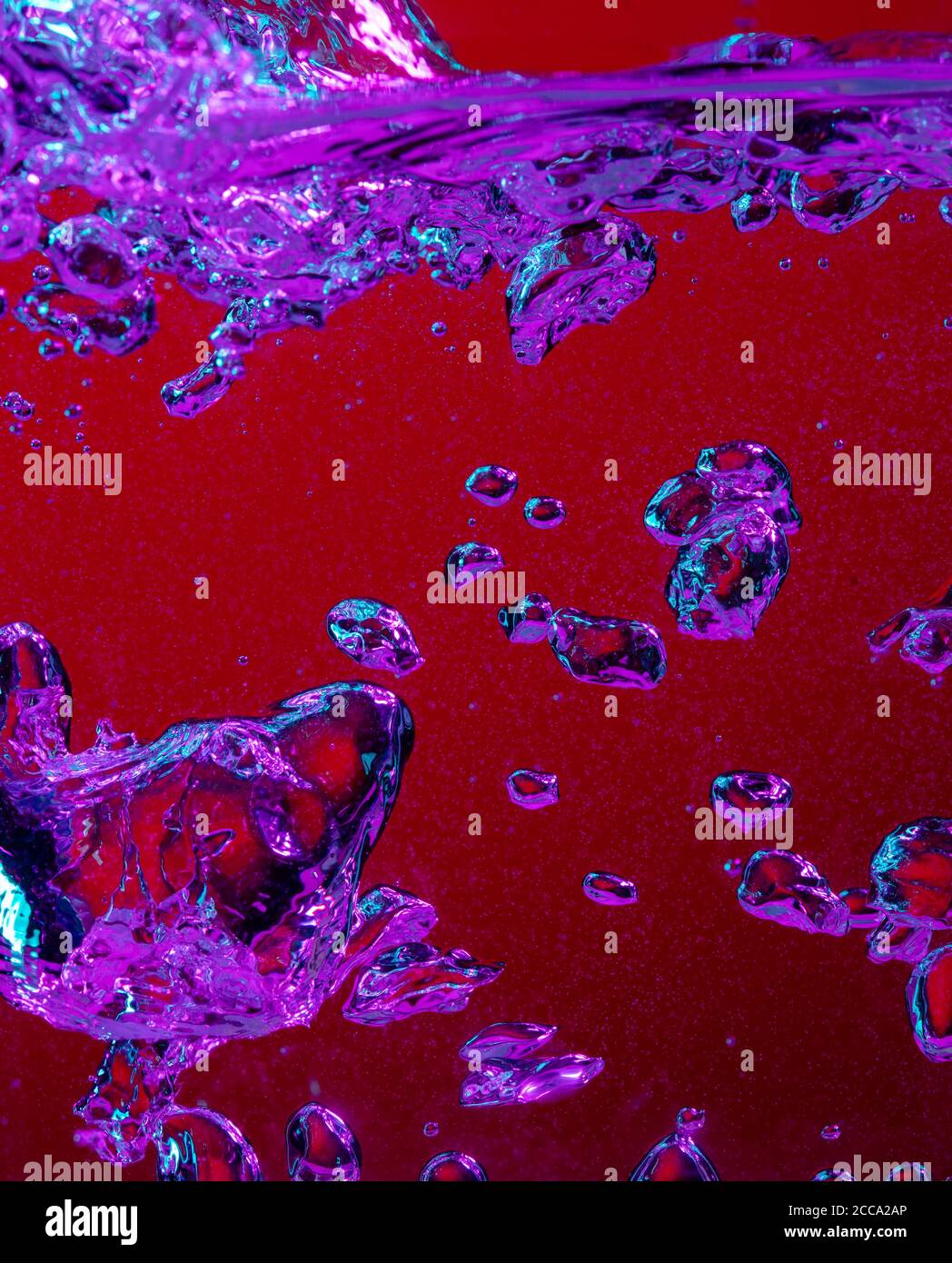 Close up view of the cold and fresh cola with bright bubbles in neon ...