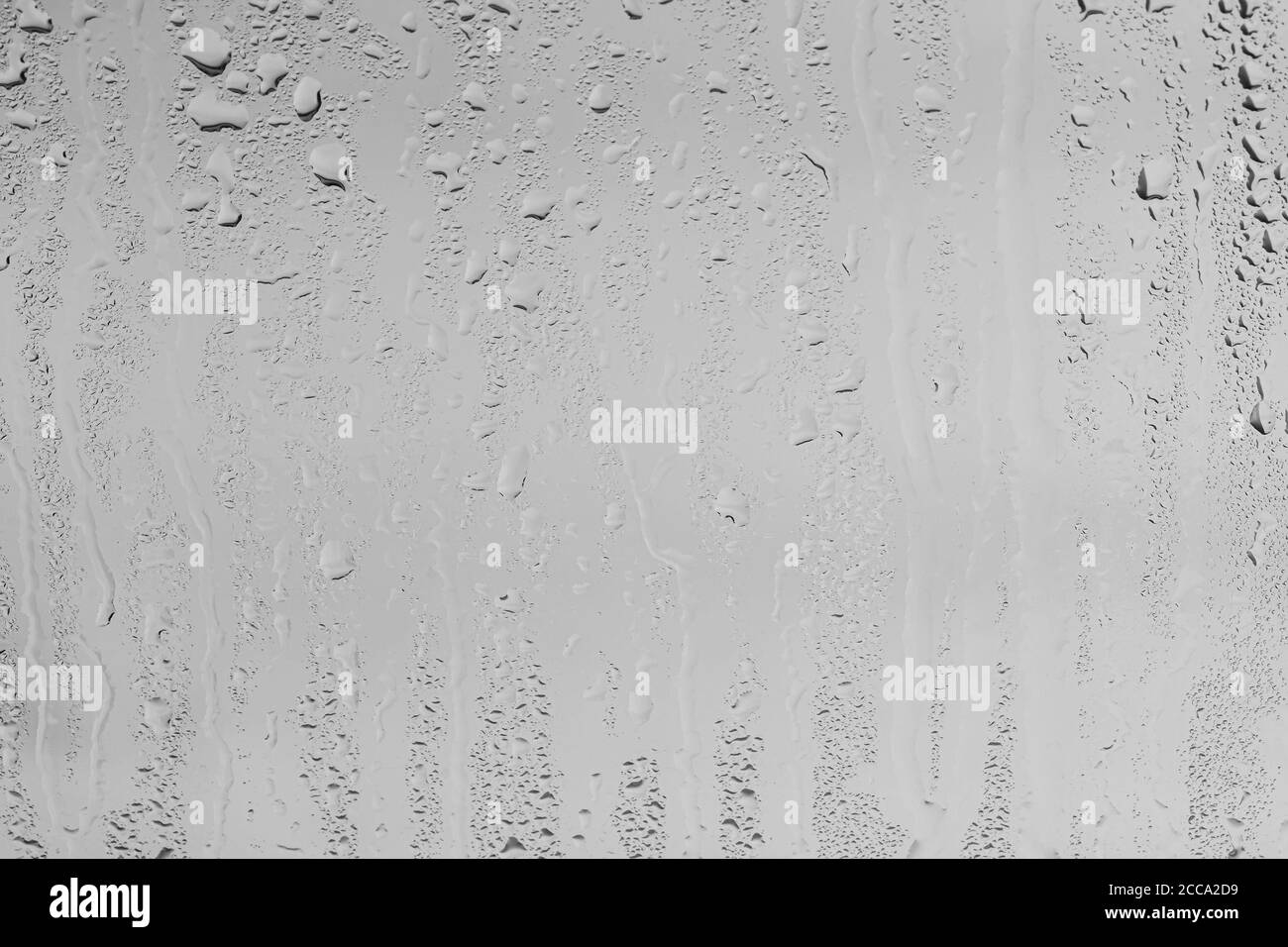 Rain drops on window glasses surface with gray sky background . Natural ...