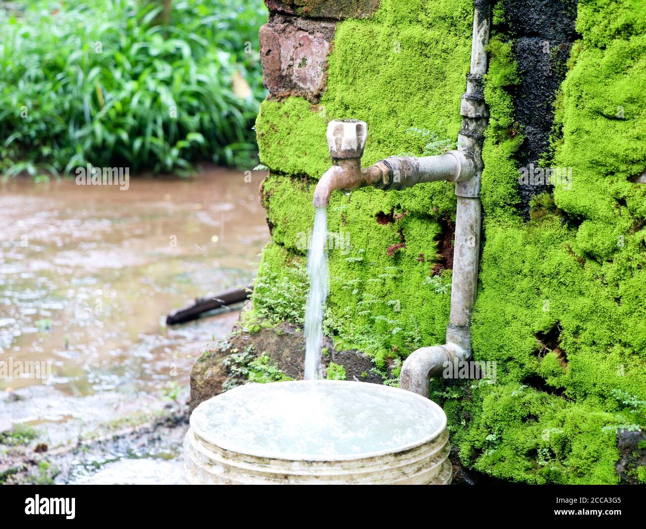 Water flowing from an old plastic water tap, vintage Stock Photo - Alamy