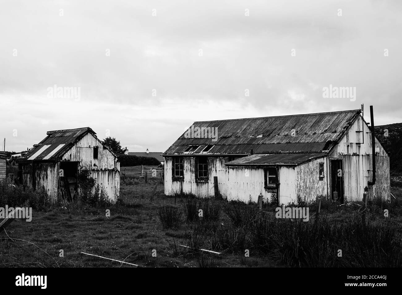 Grayscale shot of abandoned house and barn in a field Stock Photo - Alamy