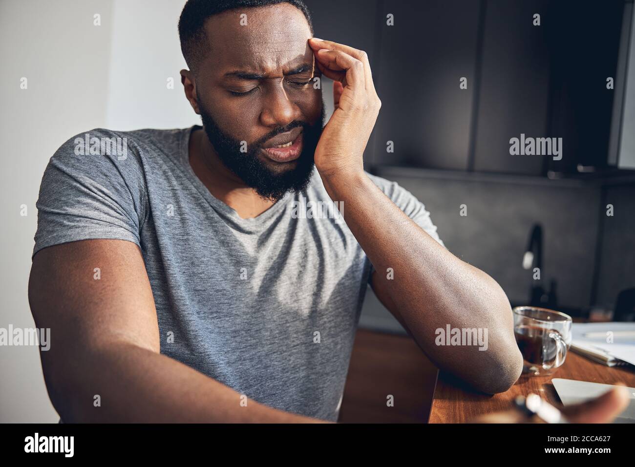 Emotional young man making face from sharp pain Stock Photo - Alamy