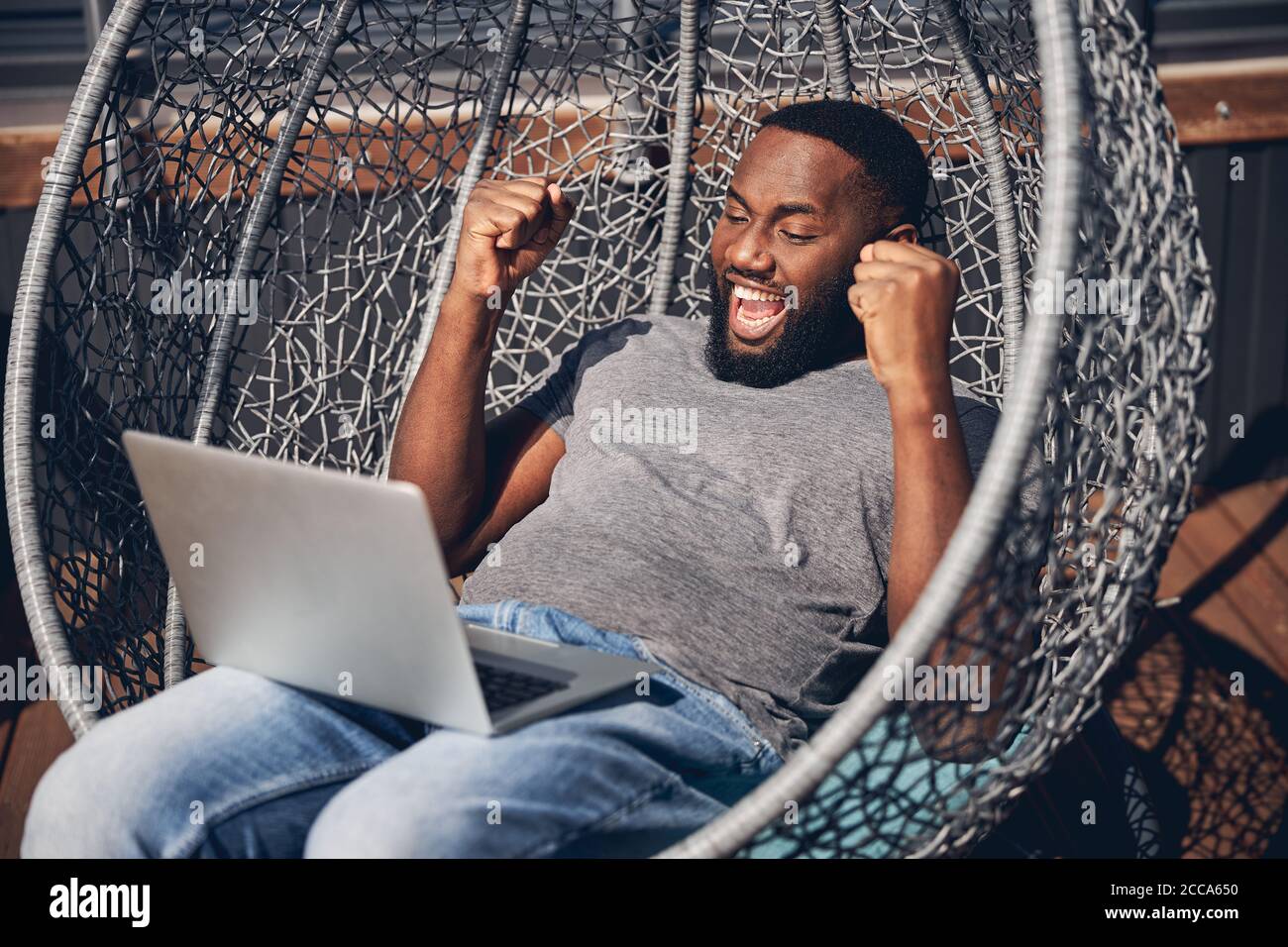 Happy male person being satisfied with the results Stock Photo - Alamy
