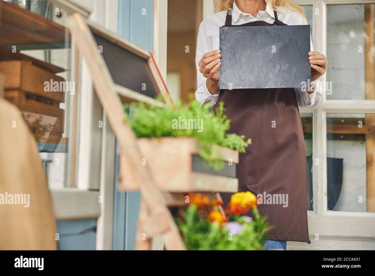 Caucasian female botanist showing an outdoor sign Stock Photo - Alamy