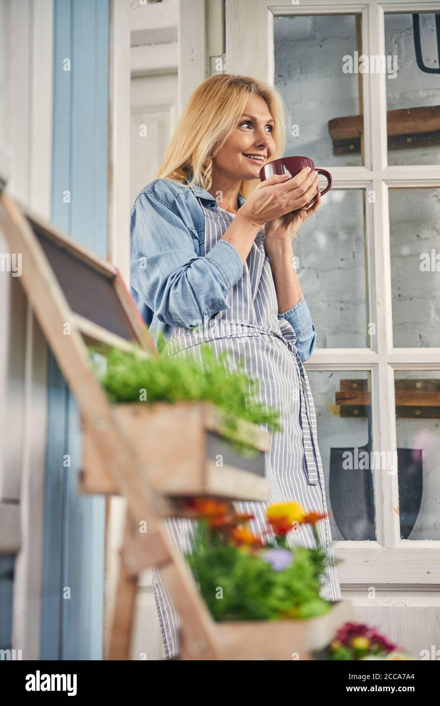 Contented mature Caucasian lady drinking coffee outside Stock Photo - Alamy