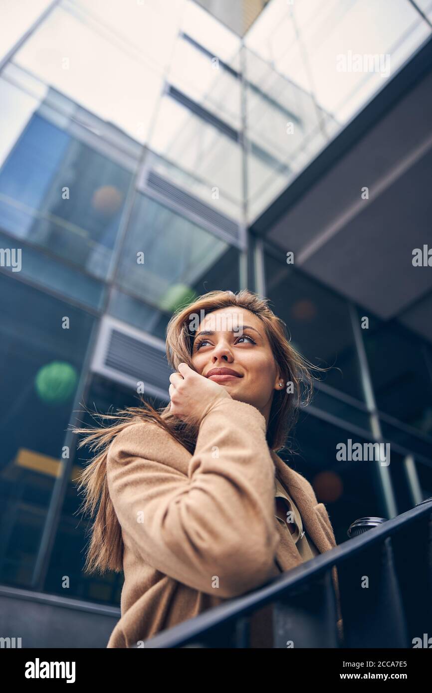 Attractive lady leaning her elbow on the rail Stock Photo - Alamy