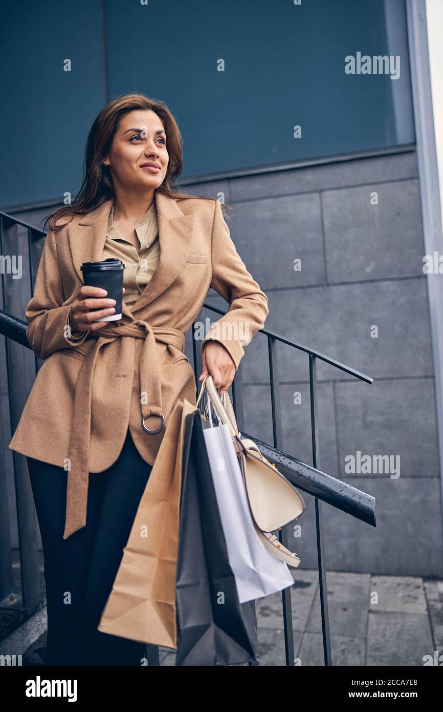 Woman leaning against rail hi-res stock photography and images - Alamy