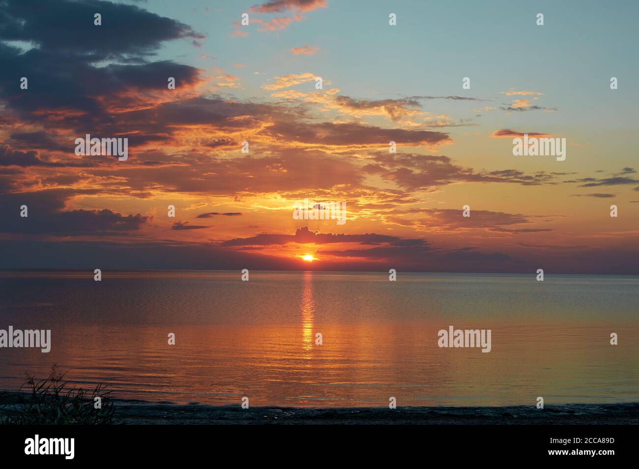 Bright sunset on the sea. A beautiful blazing baltic sea sunset and ...