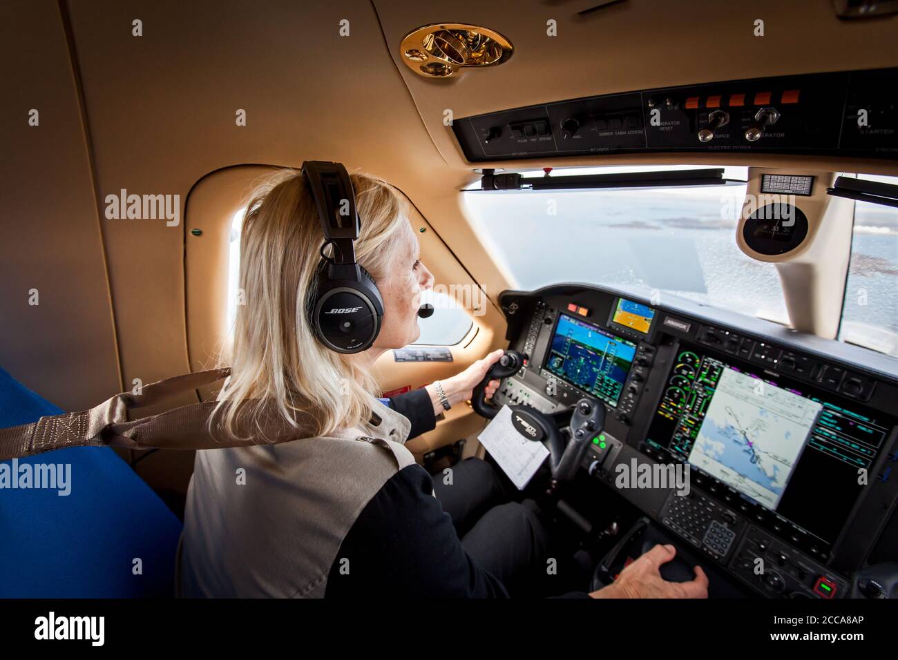 Ferry pilot Margrit Budert Walz in the cockpit, during landing approach ...