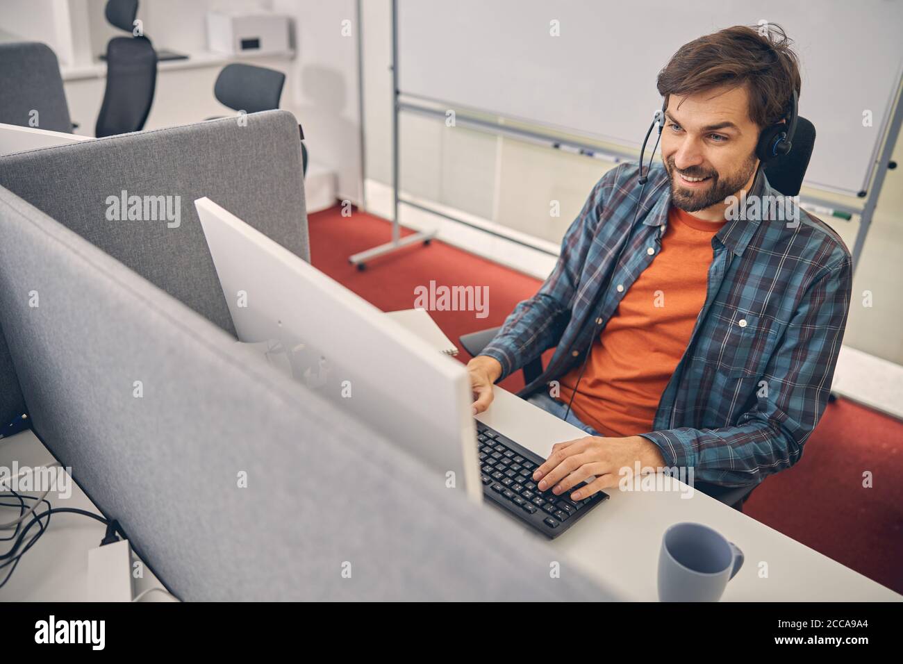 Handsome young man using computer in office Stock Photo - Alamy