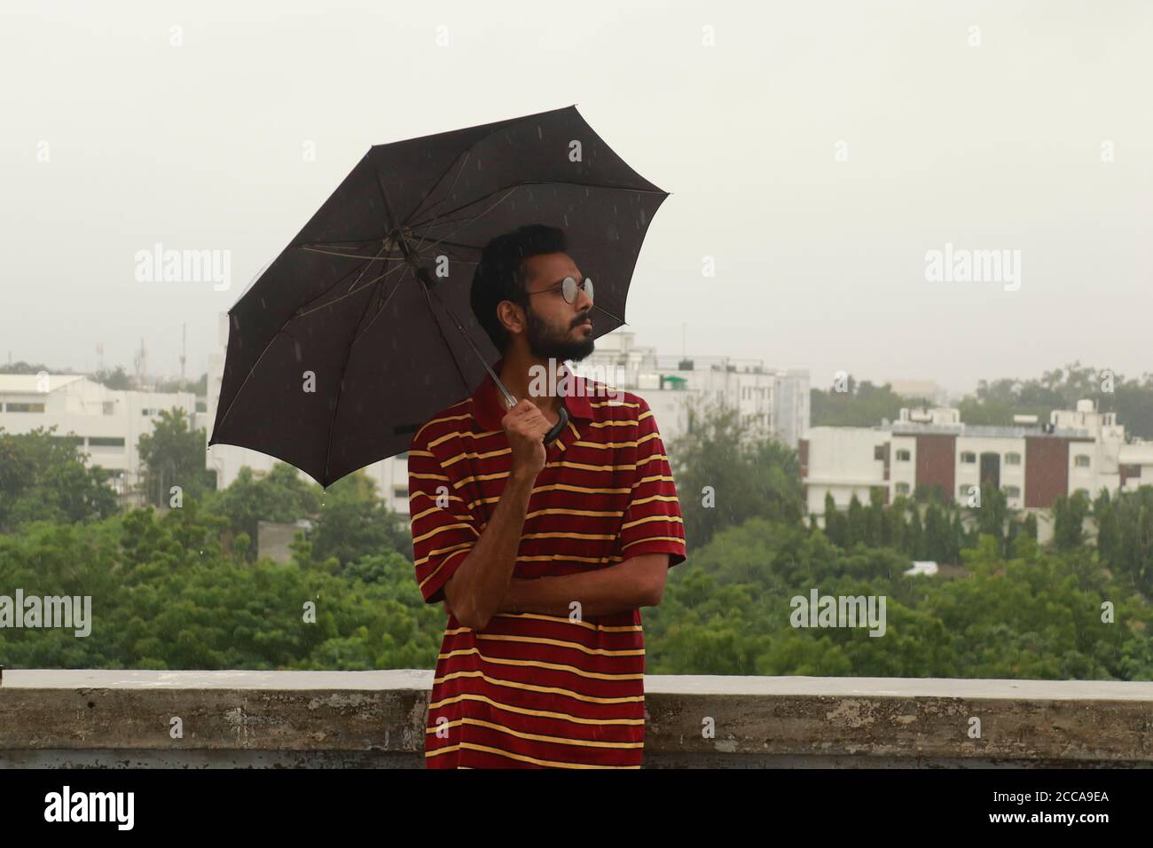 Man Standing In Rain