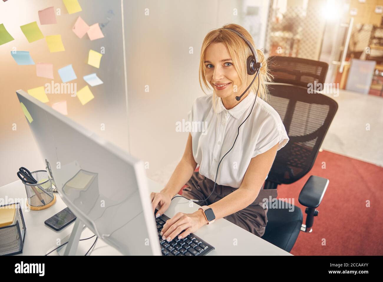 Pretty businesswoman using headset hi-res stock photography and images ...