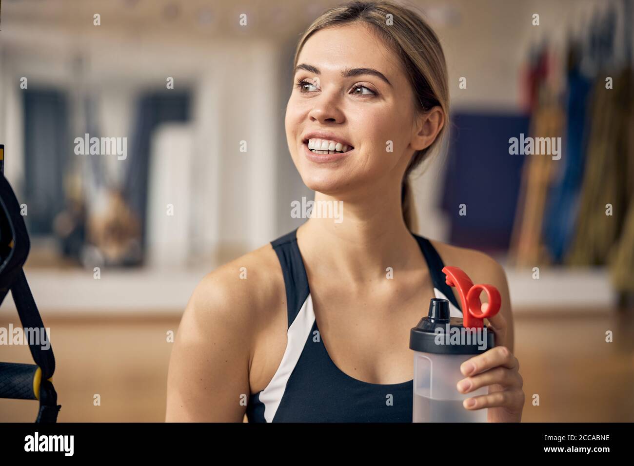Pleased female athlete relaxing after the workout Stock Photo - Alamy