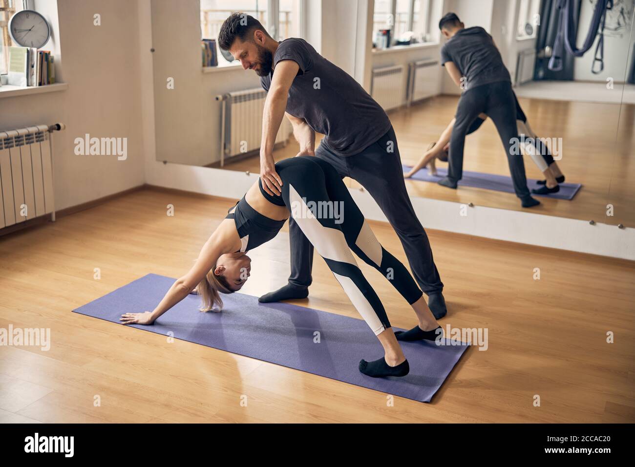 Two people training in sports classroom and smiling Stock Photo - Alamy