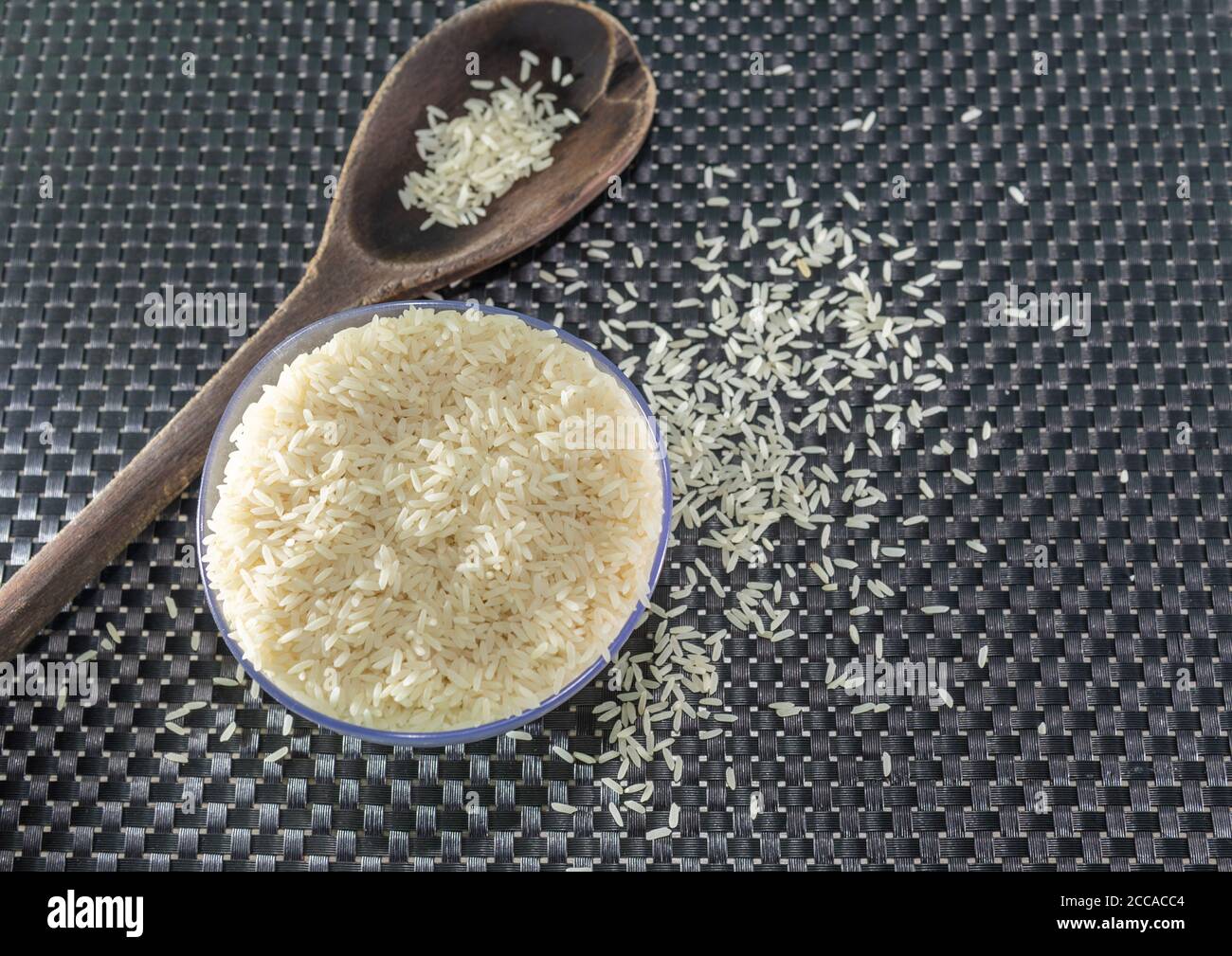 Peeled and processed grain rice on a dark background. Rice cereal and ...