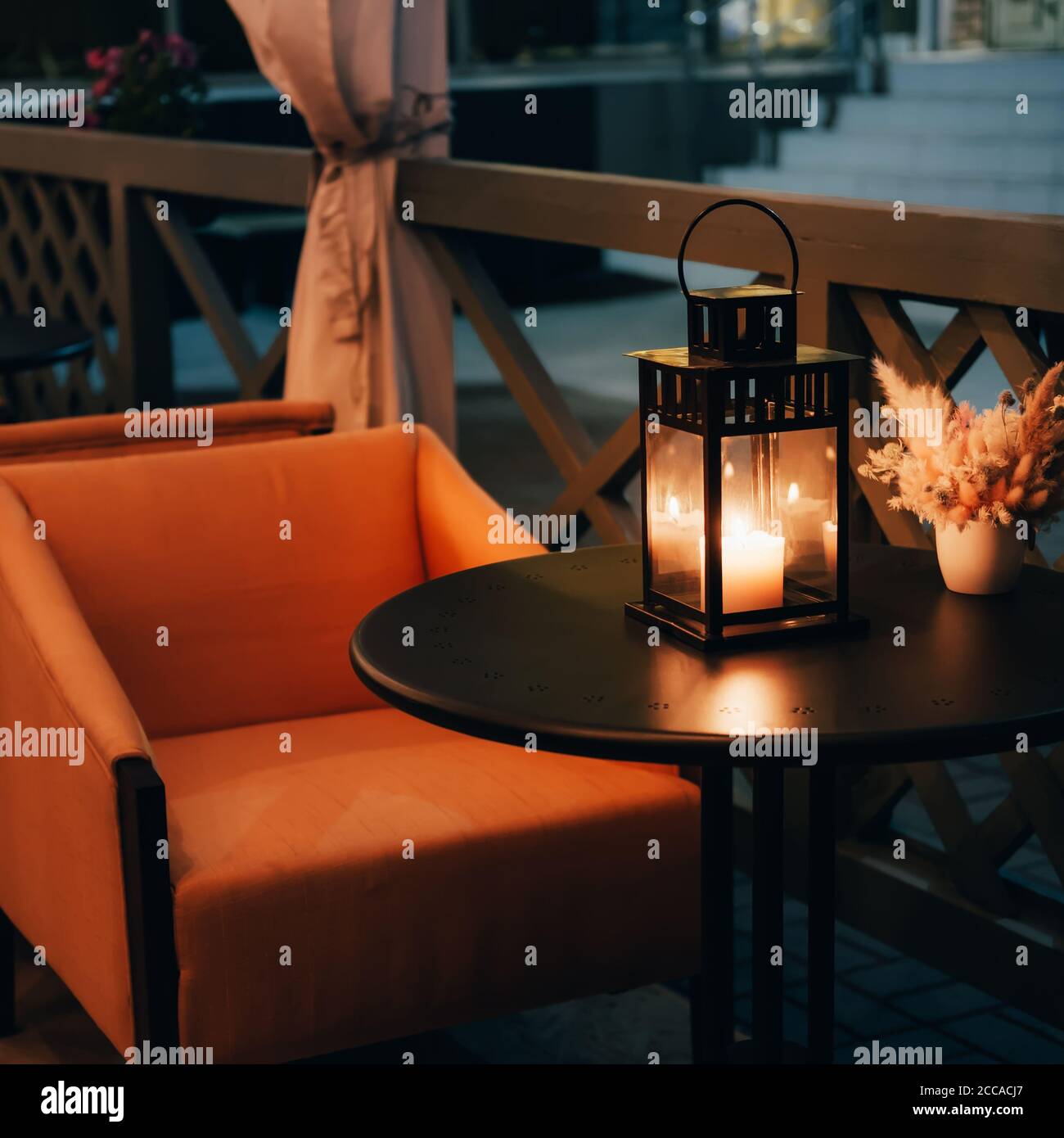 Cafe table with candles. Romantic atmosphere of street cafe. Blurred ...