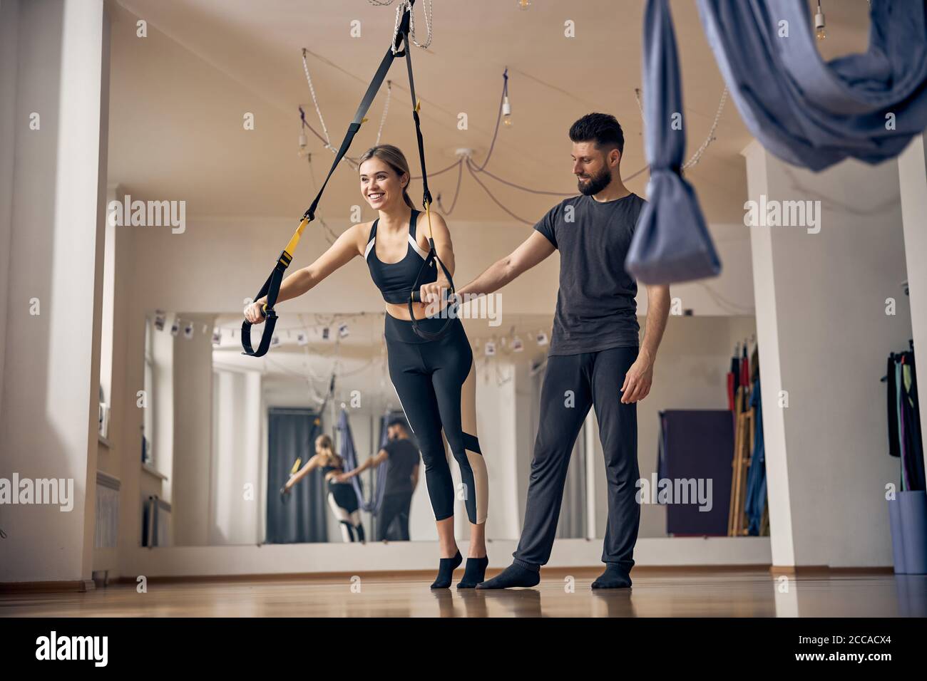 Pleased fit female doing a total body resistance exercise Stock Photo ...