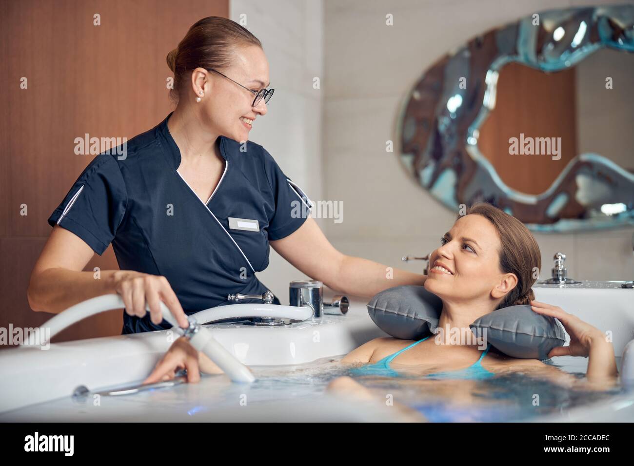 Contented lady receiving an underwater shower massage Stock Photo - Alamy