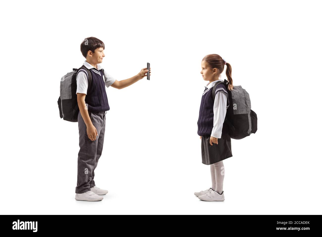 Full length profile shot of a schoolboy in a uniform standing and ...